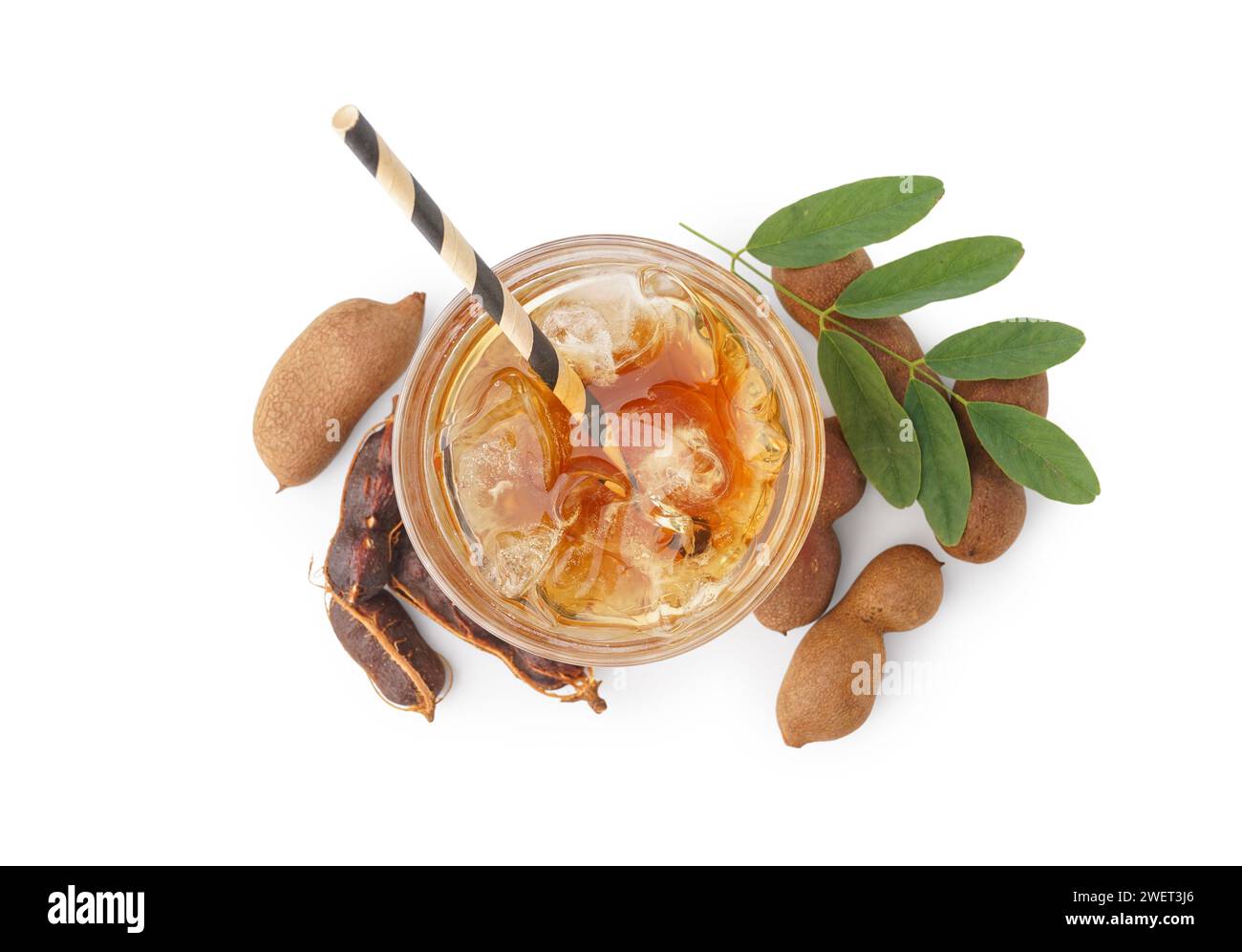 Glass of tasty tamarind drink and fruits on white background Stock ...