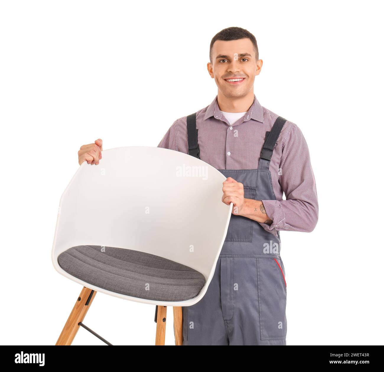Young man carrying chair hi-res stock photography and images - Alamy
