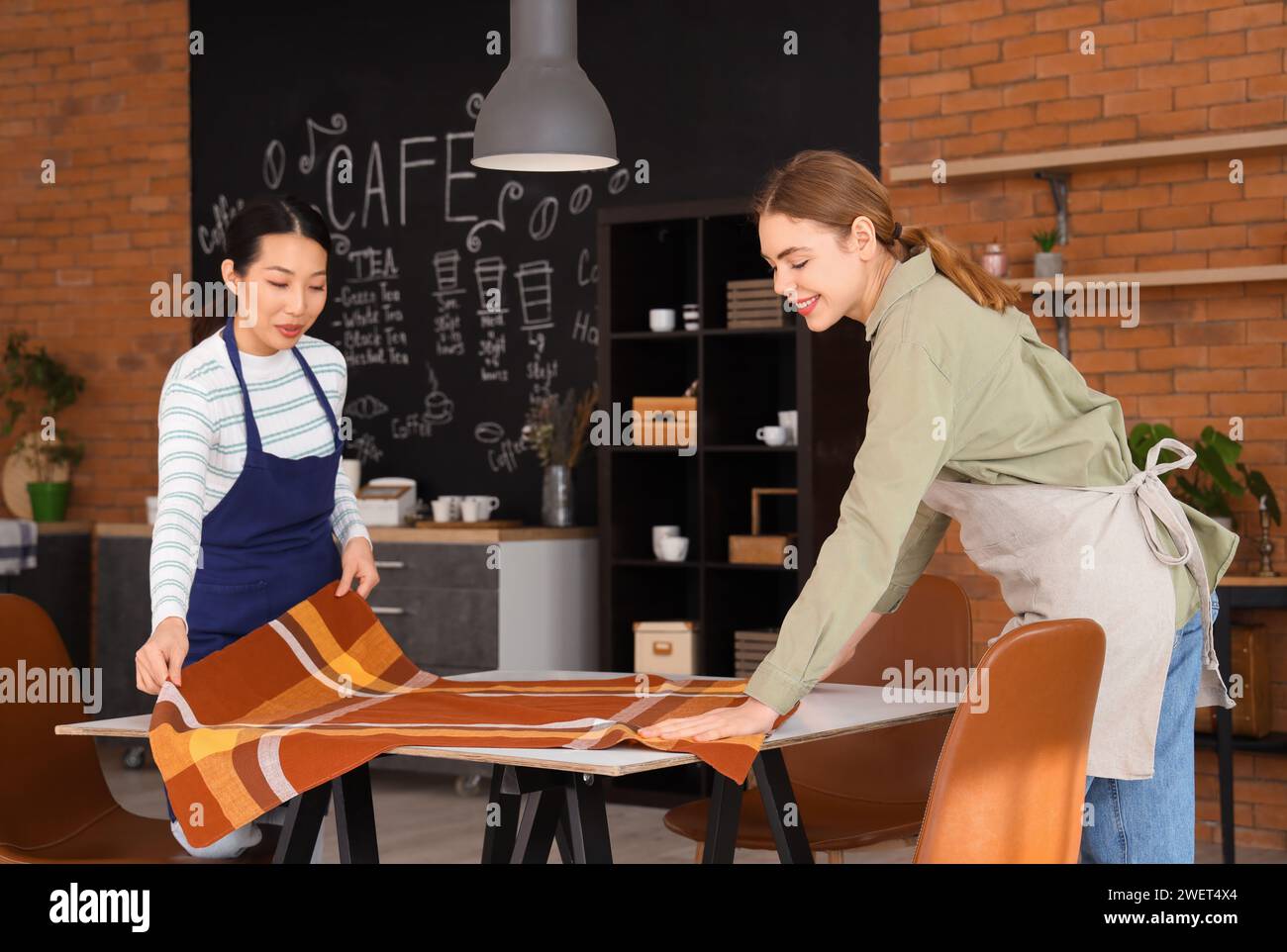 Putting table cloth on table hi-res stock photography and images - Alamy
