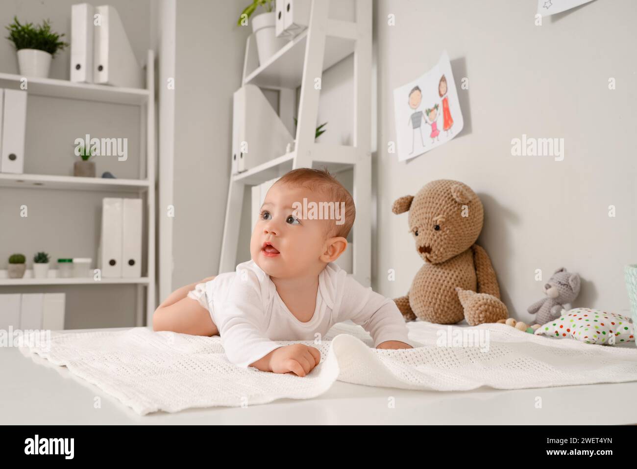 Little baby lying on table in clinic Stock Photo - Alamy