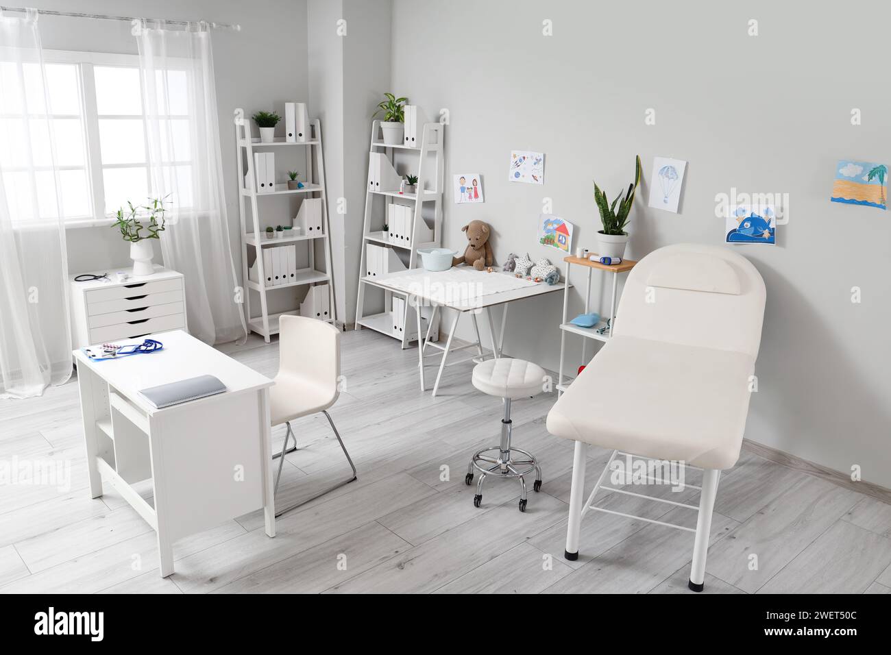 Interior of pediatrician's office with table, couch and children's ...