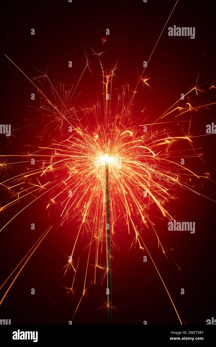 Red sparkler against dark background hi-res stock photography and ...