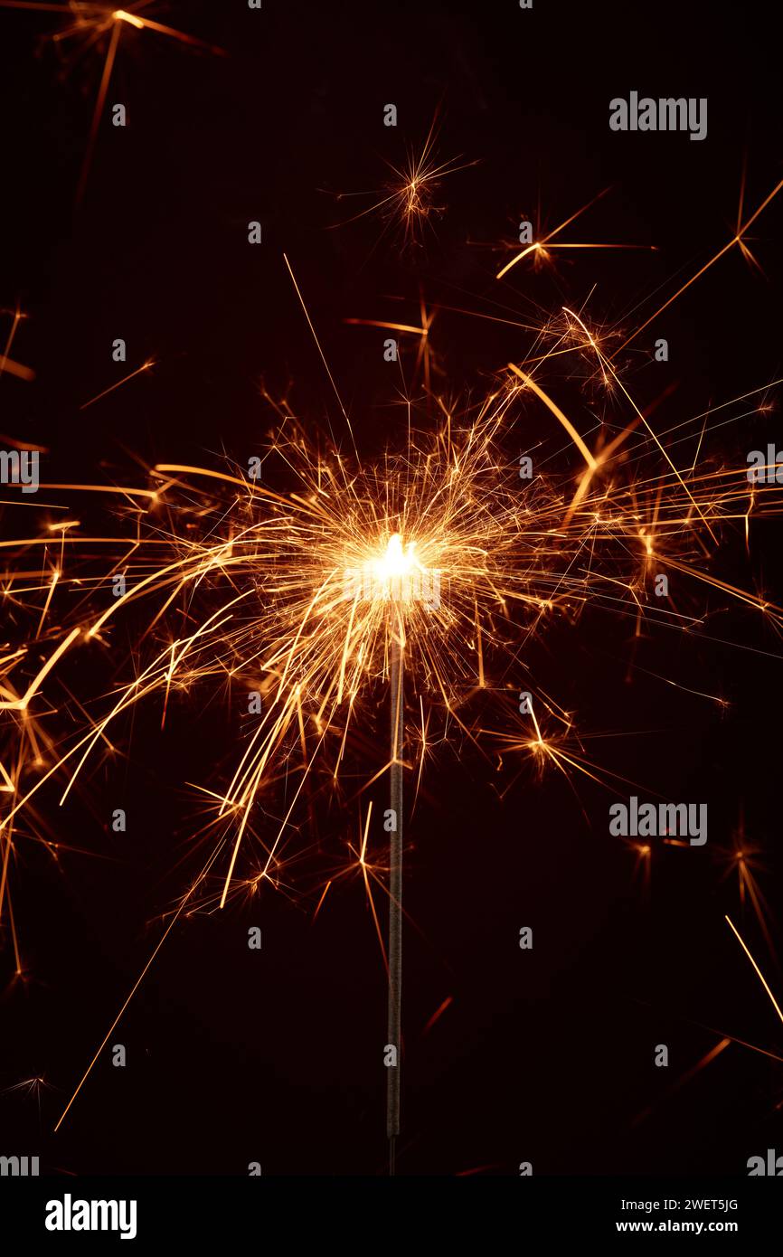 Photograph of the sparkler with bright sparks on black background ...