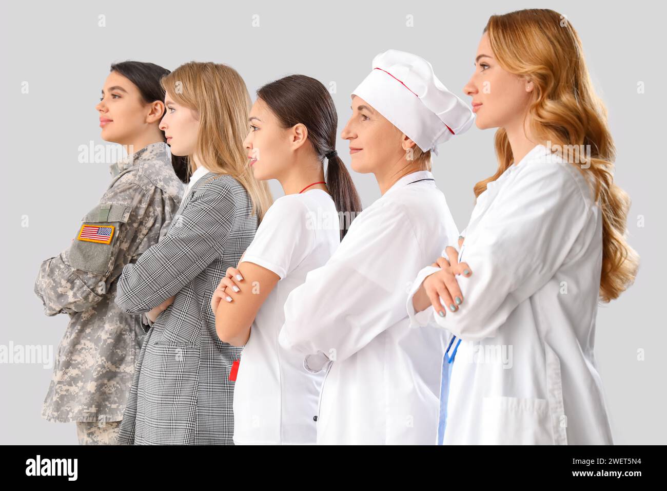 Women of different professions with crossed arms on grey background ...