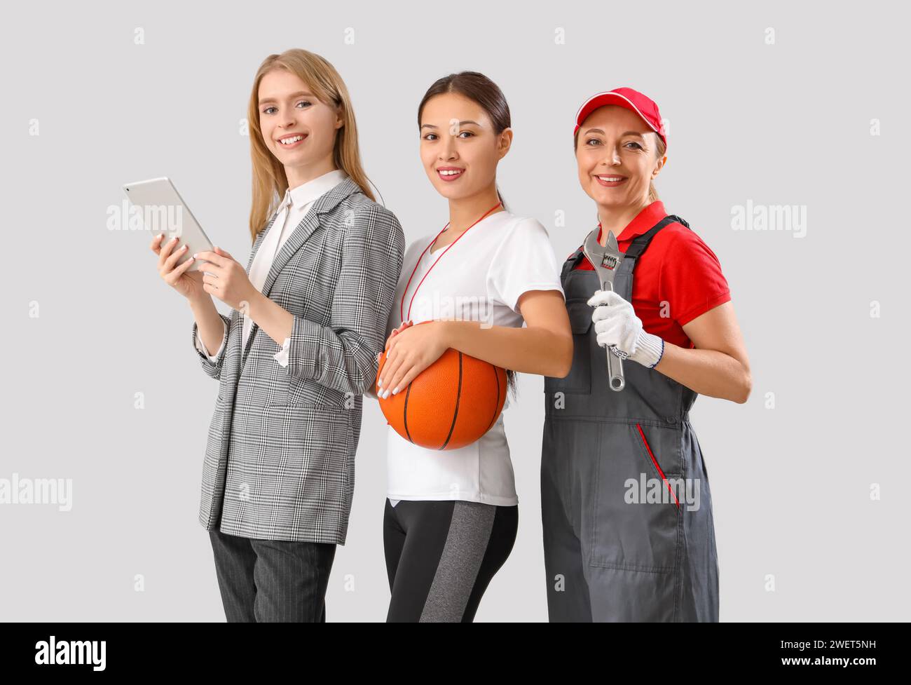 Women of different professions on grey background Stock Photo - Alamy