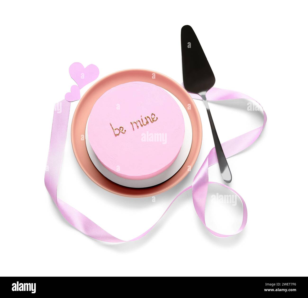 Pink bento cake with spatula and ribbon on white background. Valentine ...