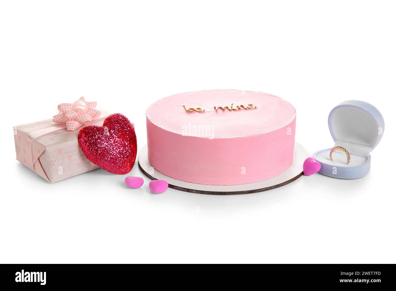 Pink bento cake with gift box and engagement ring on white background ...