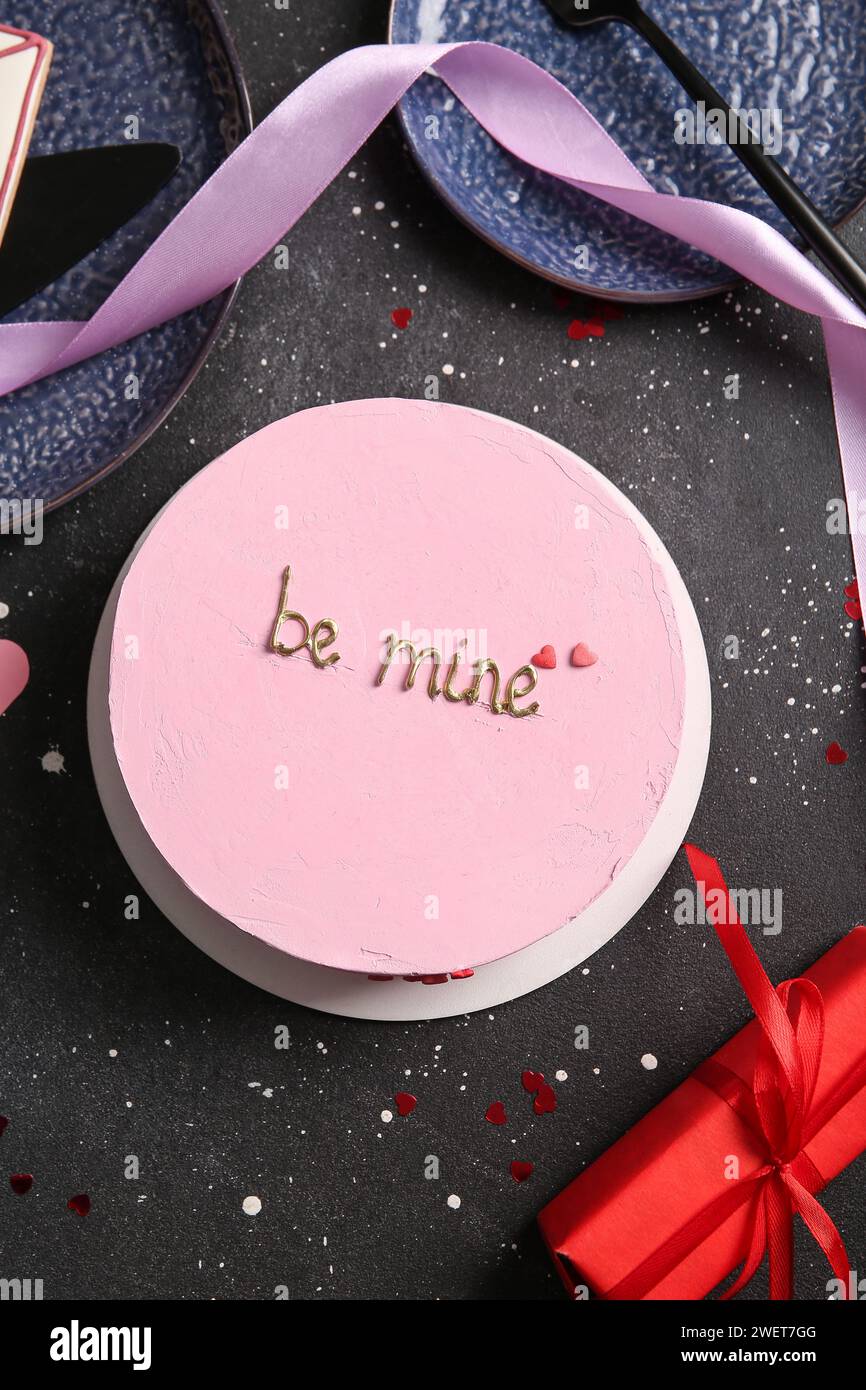 Pink bento cake with gift box and ribbon on black grunge background ...