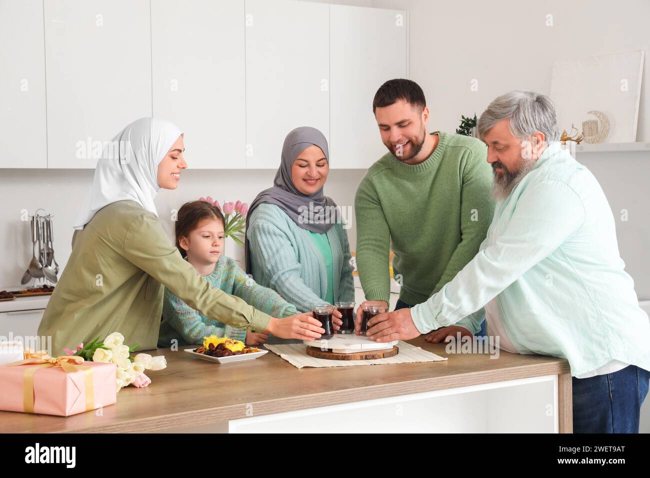 Happy Muslim family with tea in kitchen. Ramadan celebration Stock ...