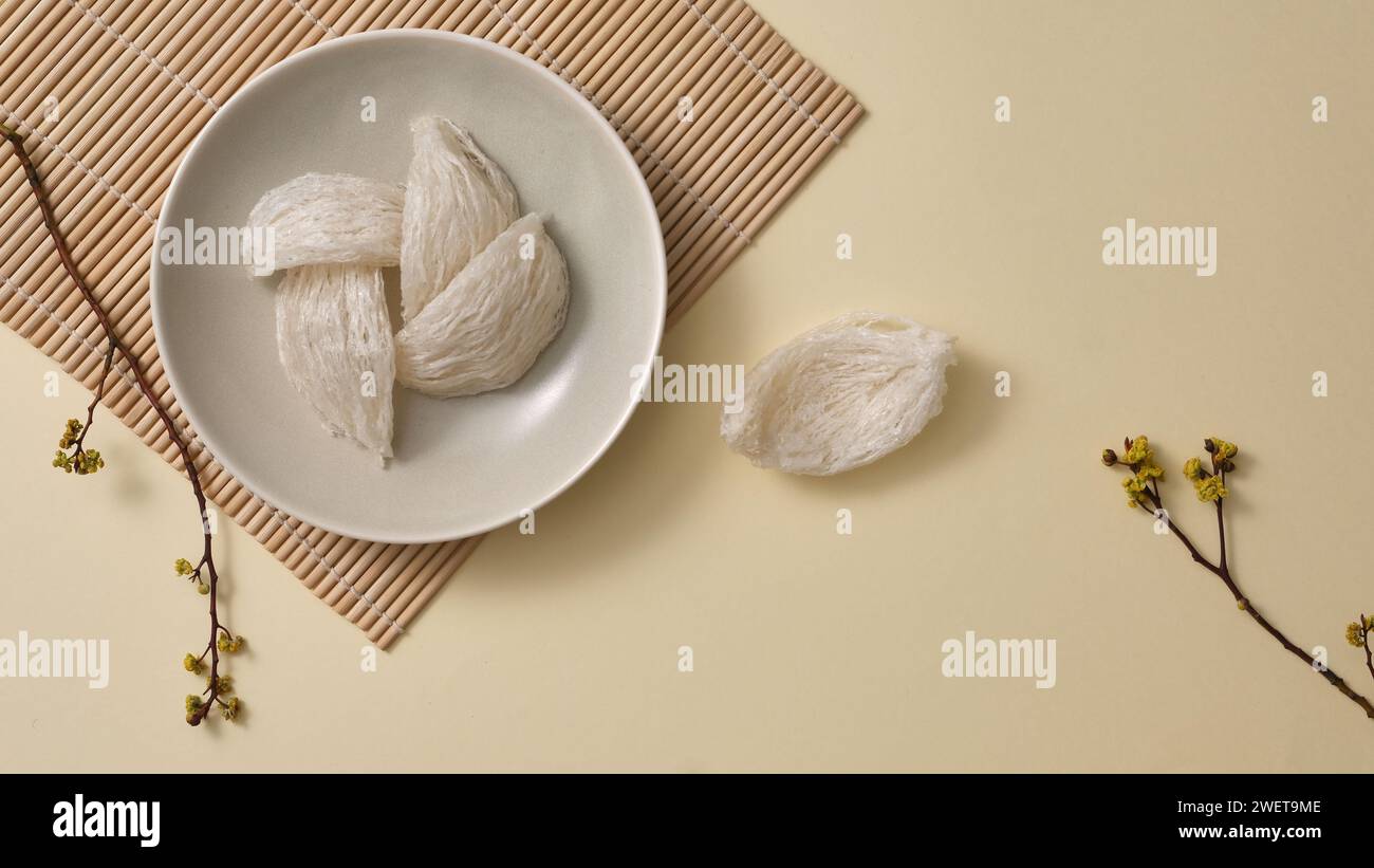 Top view of raw bird's nest neatly arranged in round dishes, small ...