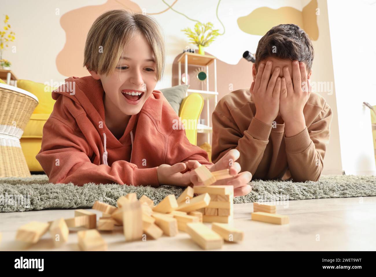 Happy brothers playing game at home Stock Photo - Alamy