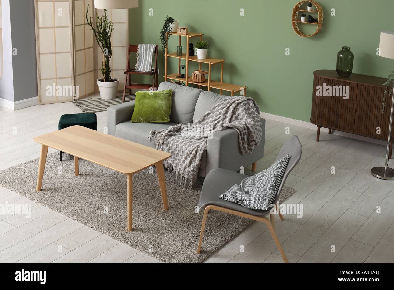 Interior of stylish living room with sofa, table and chair Stock Photo ...