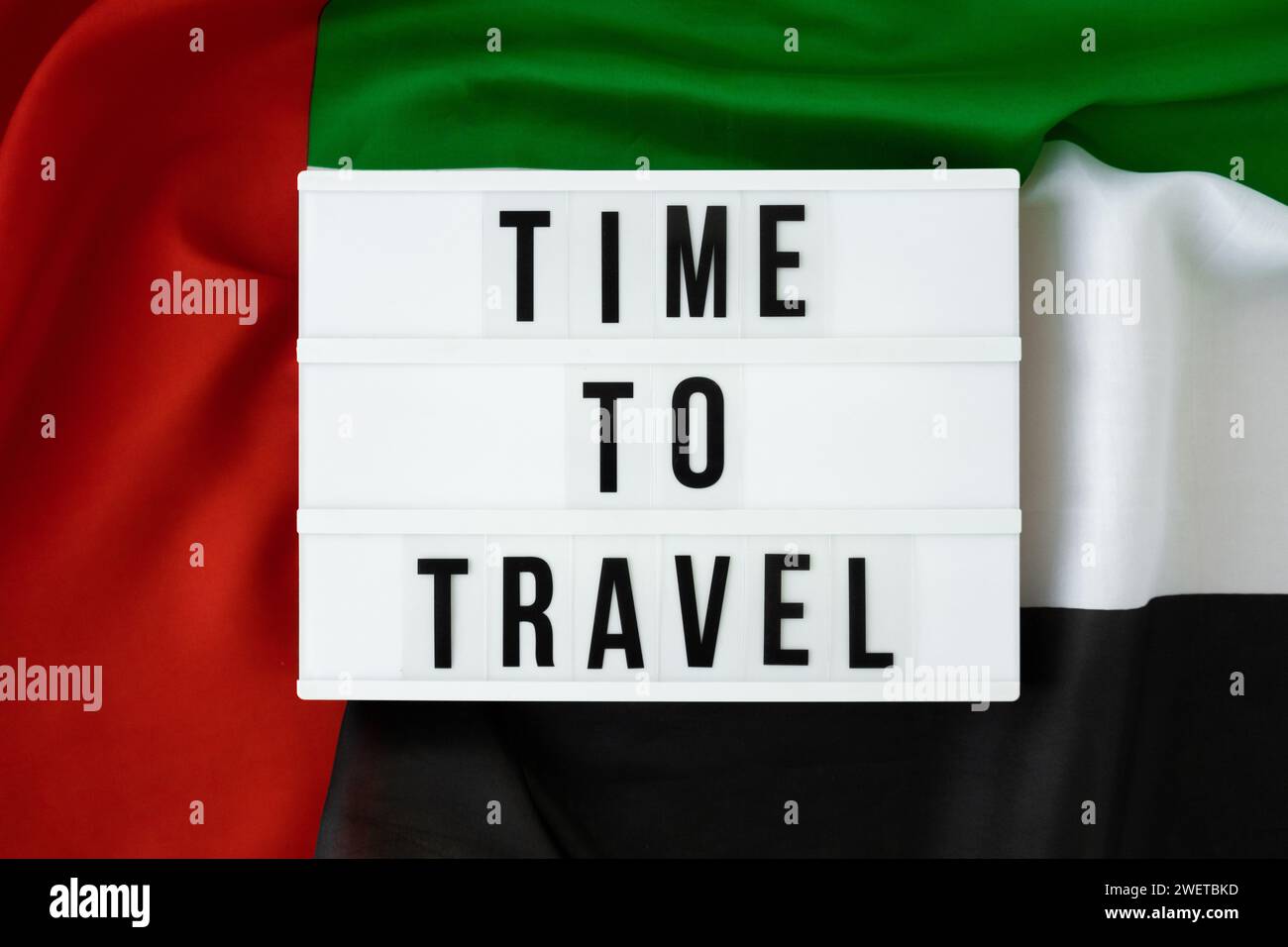 Message with text TIME TO TRAVEL on background of waving UAE flag made ...