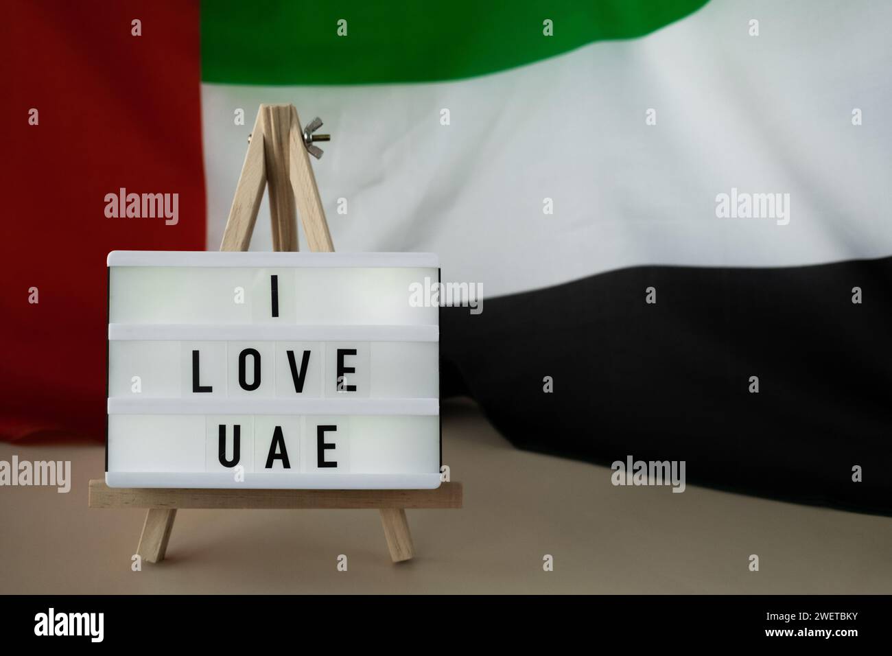 Message text I LOVE UAE on background of waving UAE flag made from silk ...