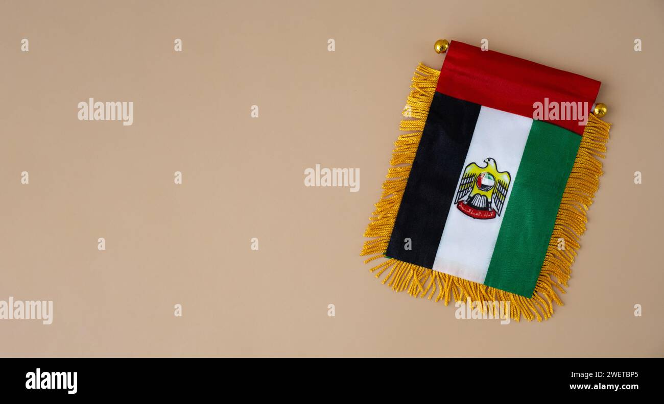 National symbol of UAE. United Arab Emirates small flag with Peregrine ...