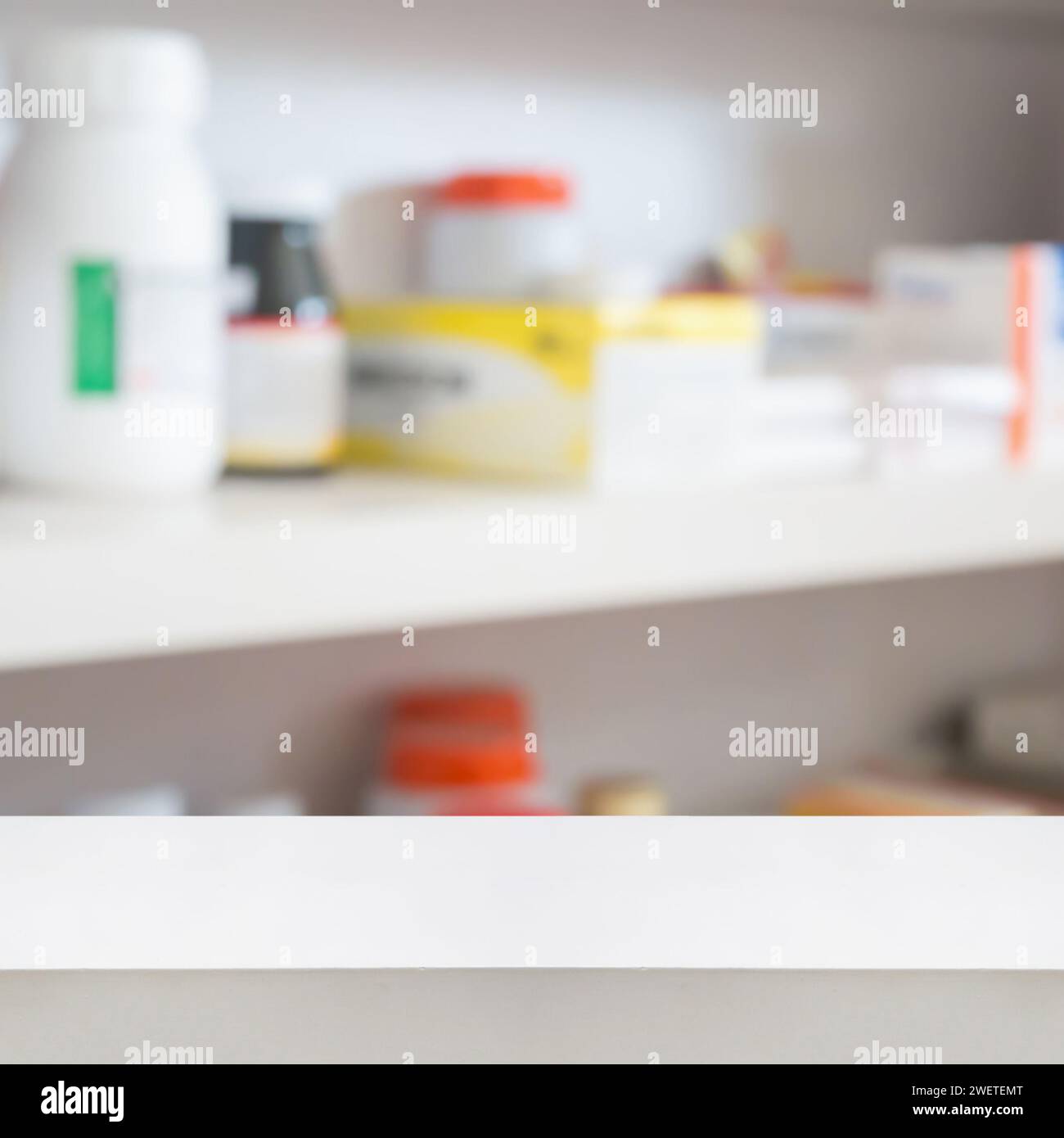 Blank white pharmacy table counter with blur shelves of drug in the ...