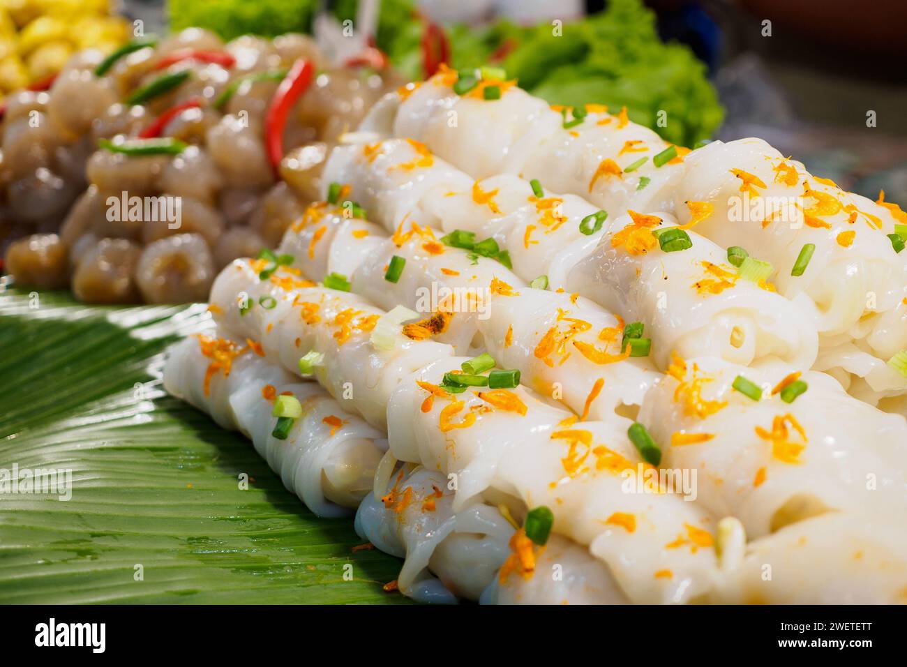 rice noodle crepe roll with shrimp, pork and vegetable on banana leaf ...
