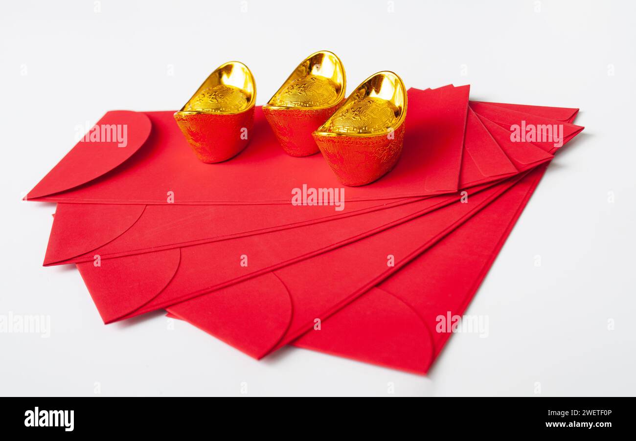 Chinese New Year red packet and golden ingot on white cover. Chinese ...