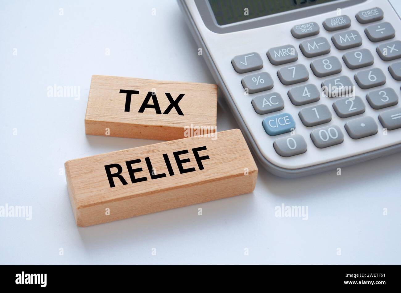 Tax relief text on wooden blocks on white cover background with ...