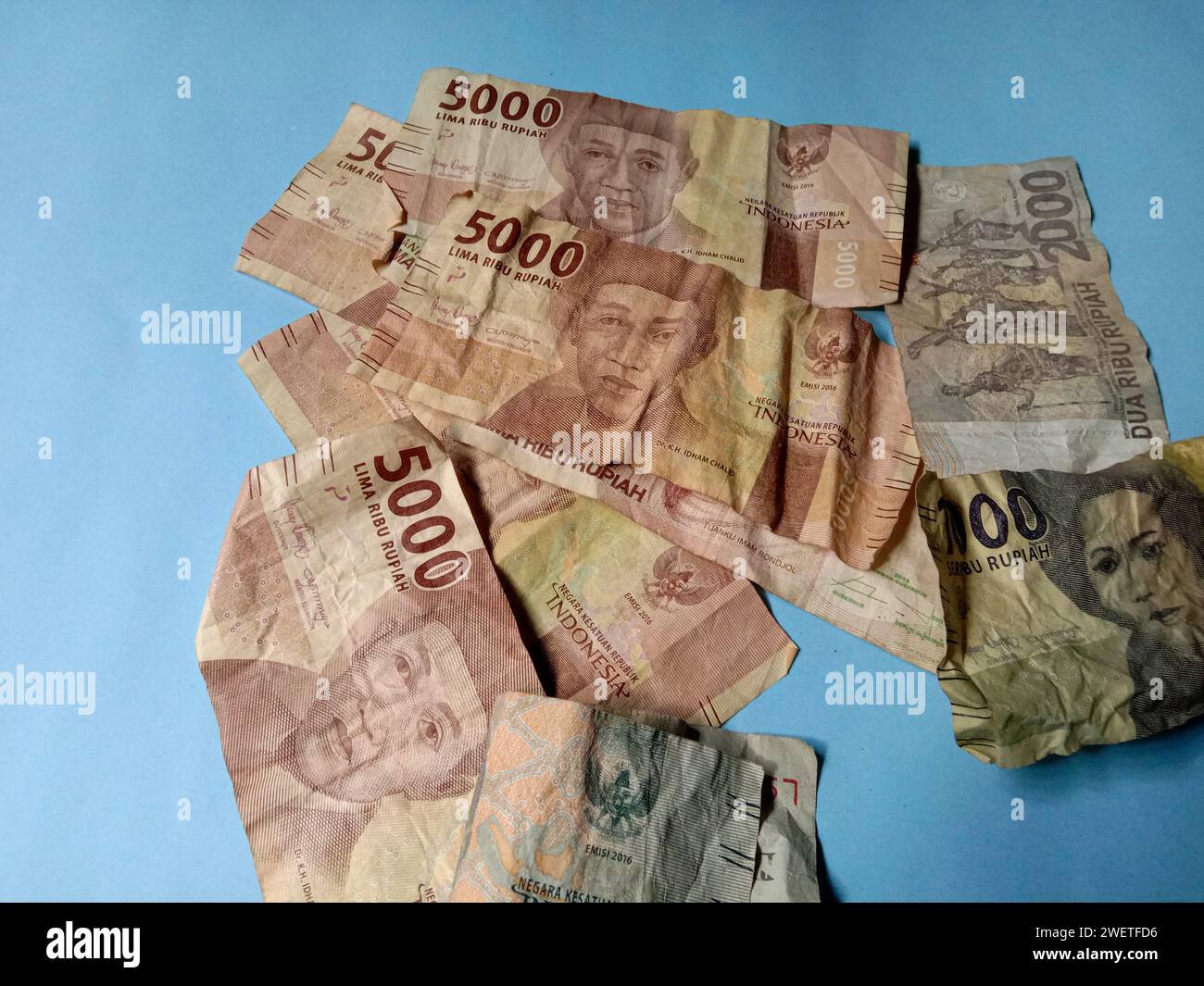 Stock photo of rupiah money objects, markers and cups on a blue ...