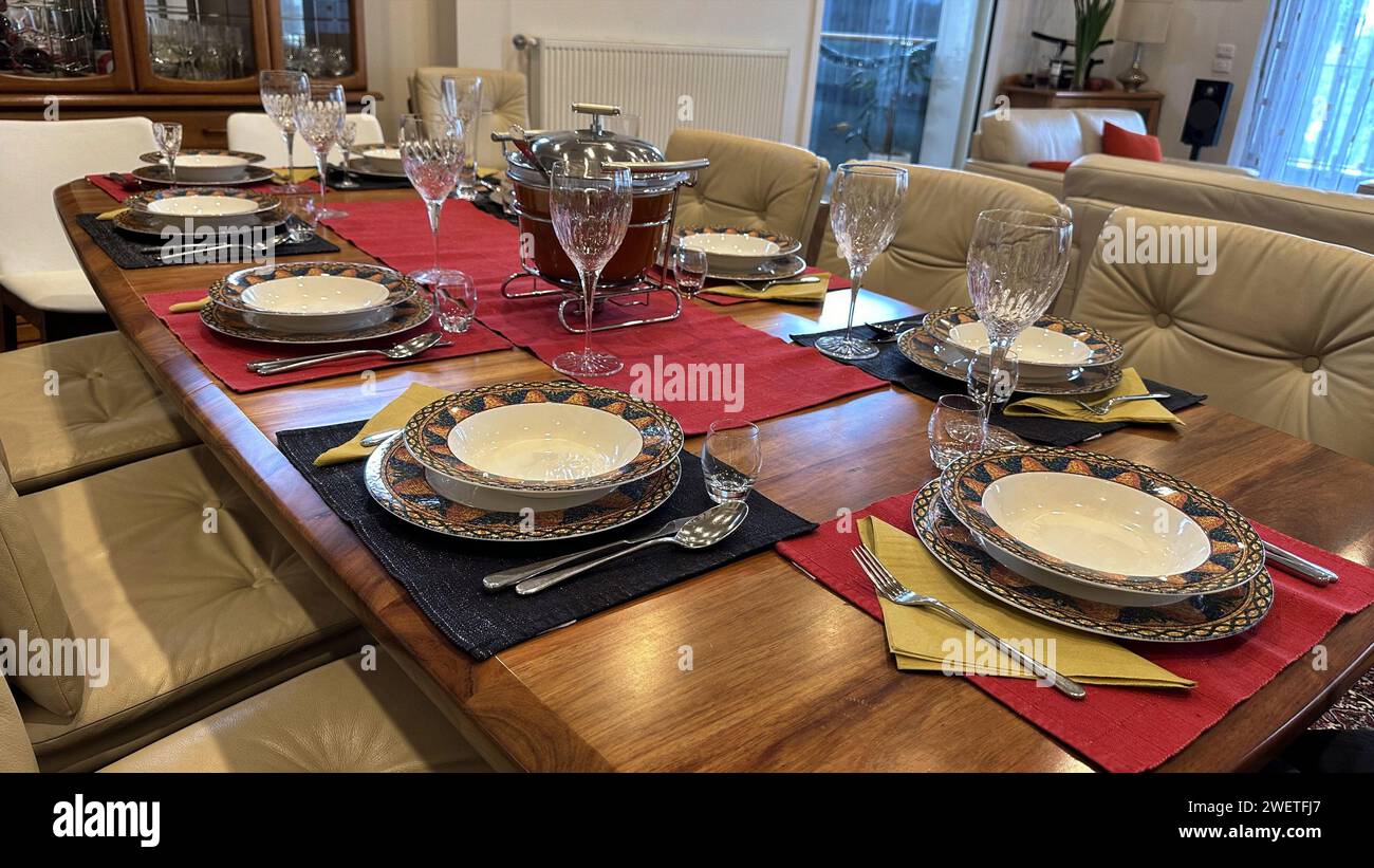 Table in living room prepared for dinner Stock Photo - Alamy
