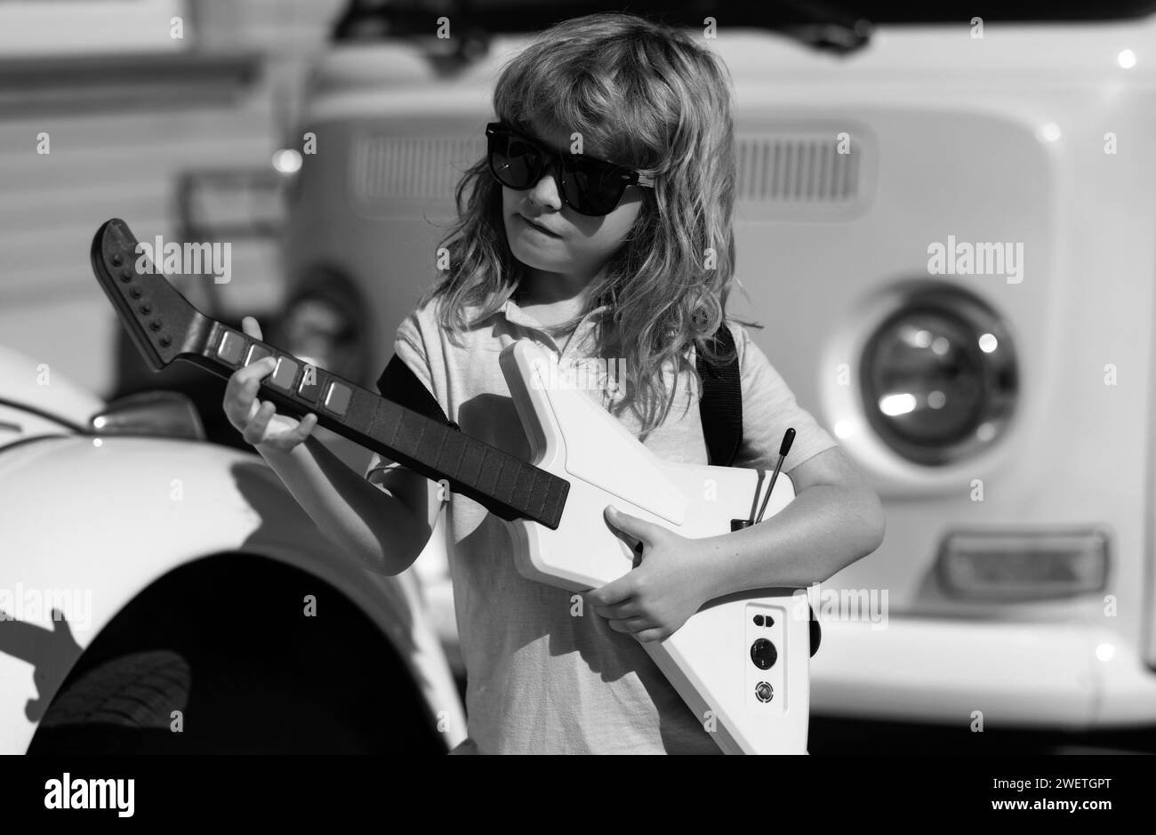 Child musician playing the guitar like a rockstar outdoor. Kid boy rock ...