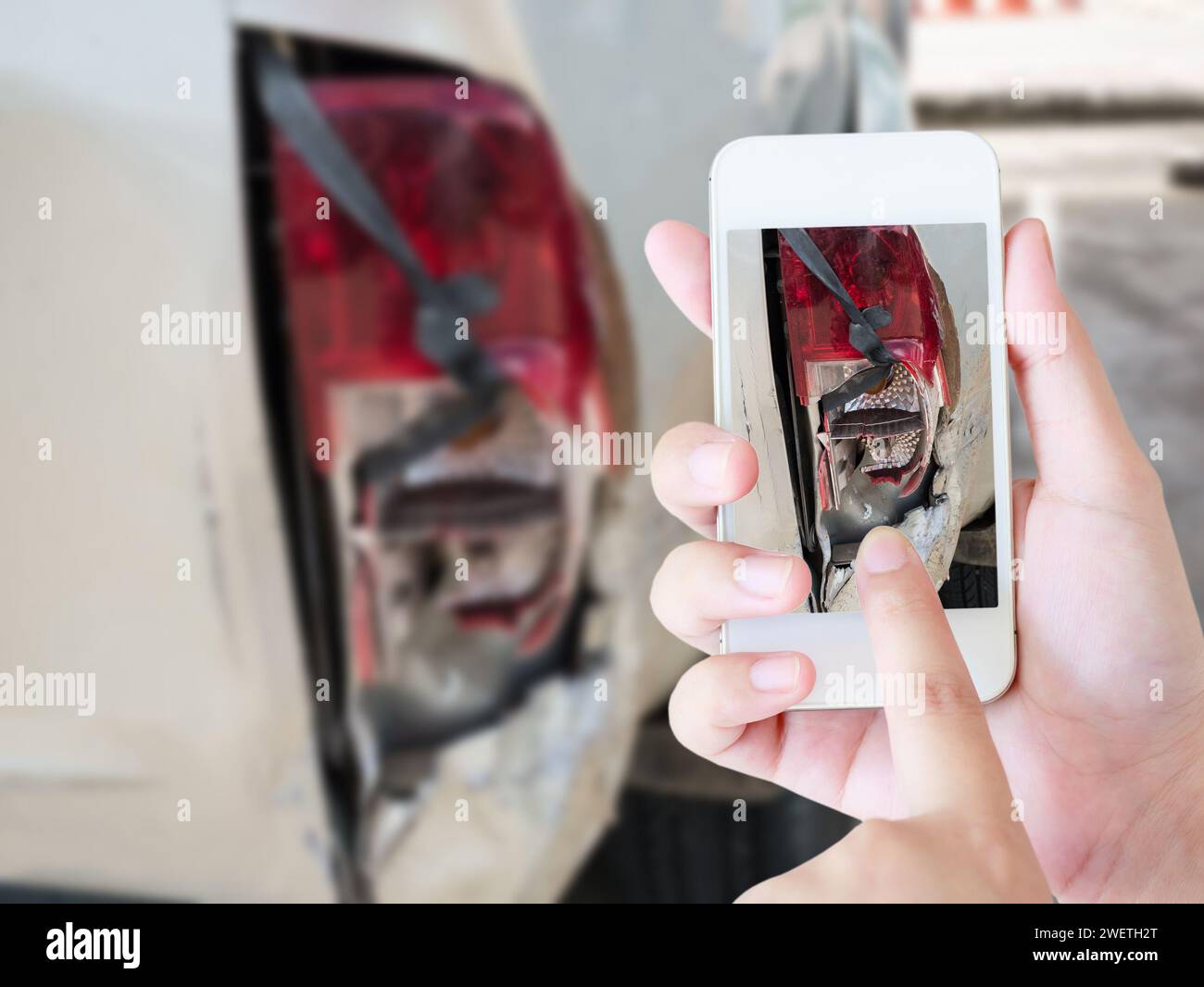 woman using smart phone to take car damage photo caused by car crash ...