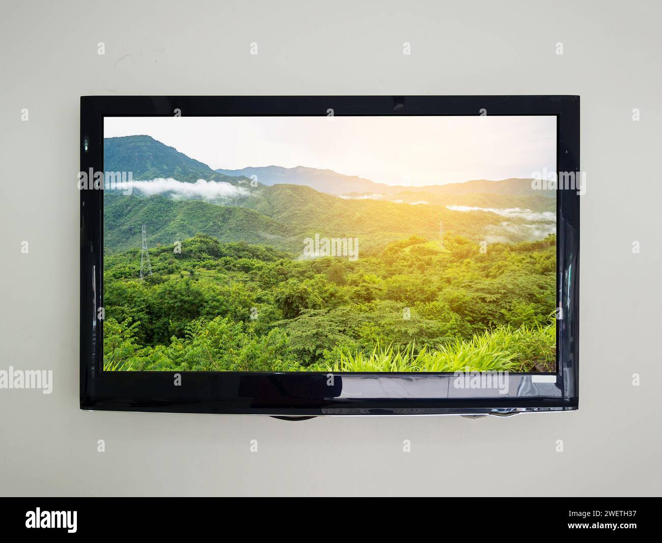 Led tv on the wall background with nature scene on television screen ...