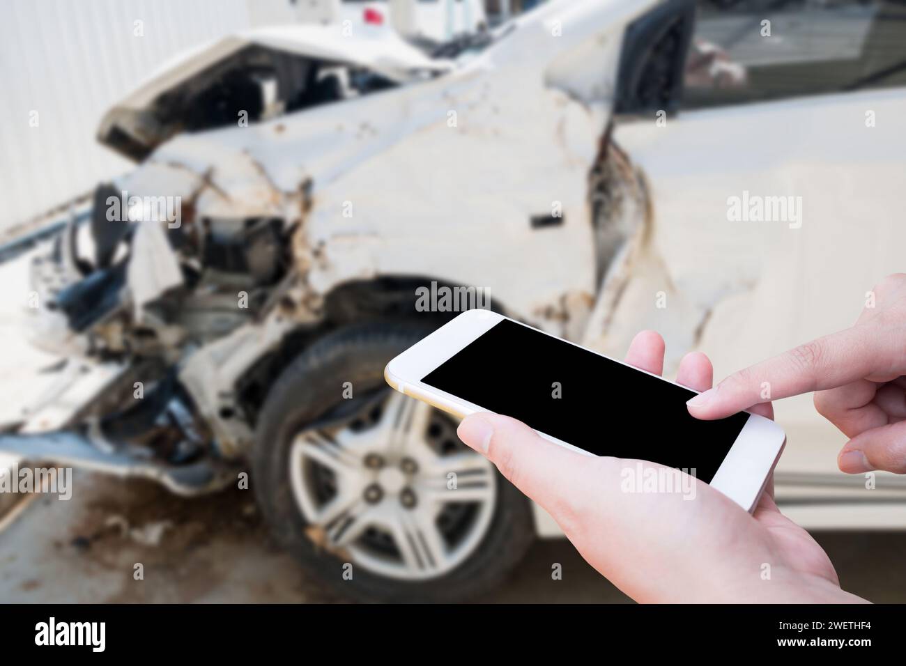 Female using mobile smart phone taking photo of the car crash accident ...