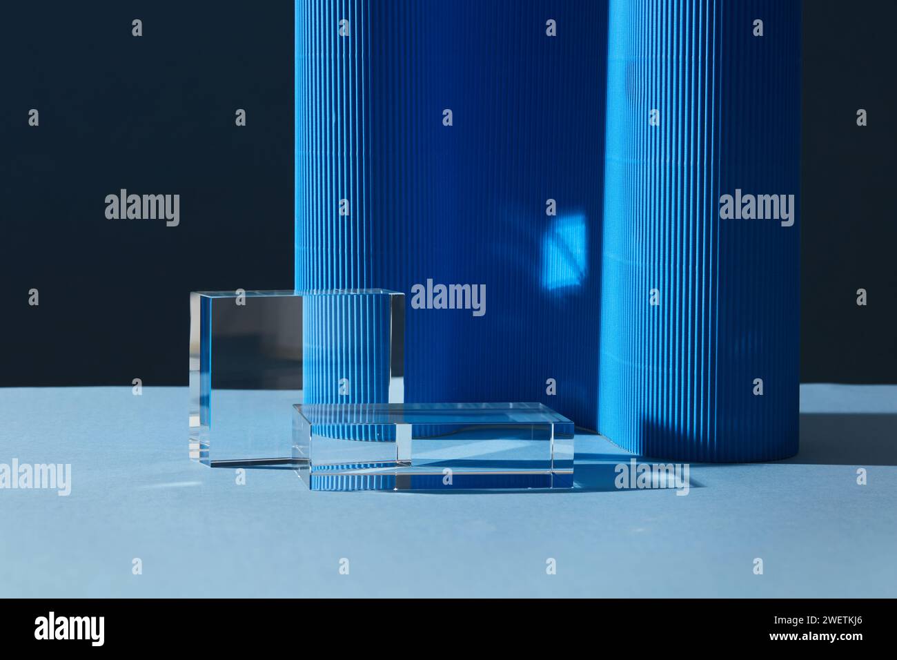 Two transparent geometric blank podiums decorated on dark background ...