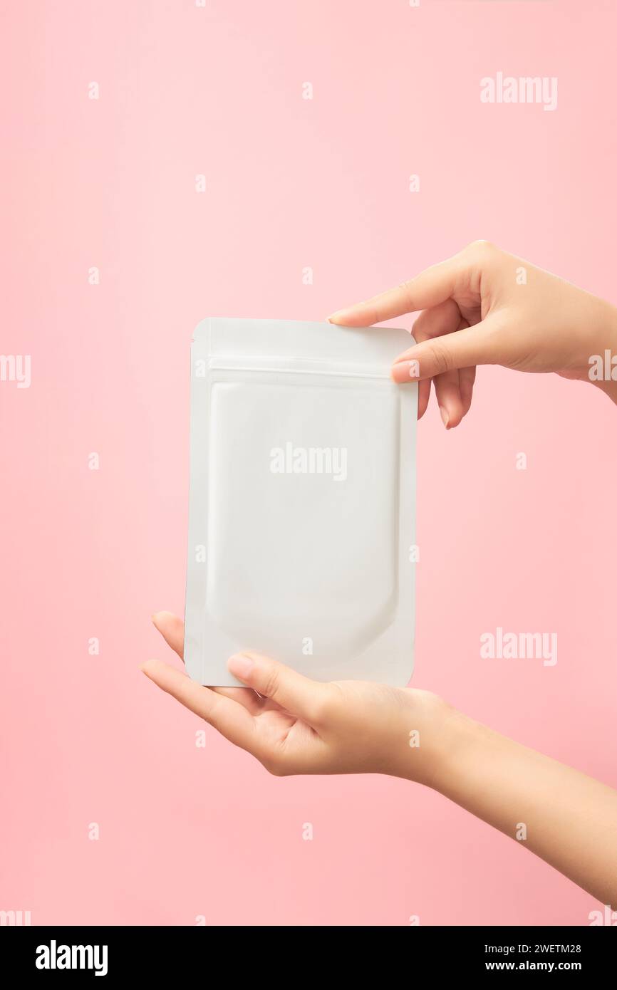 Beauty female hands holding a facial sheet mask packaging mockup on ...