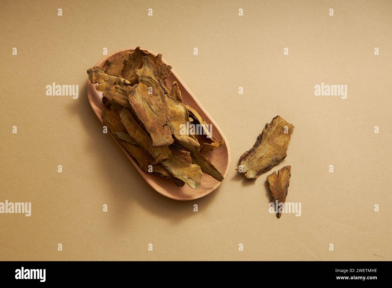 Angel view of rhizoma rhei put on wooden dishes on light brown ...