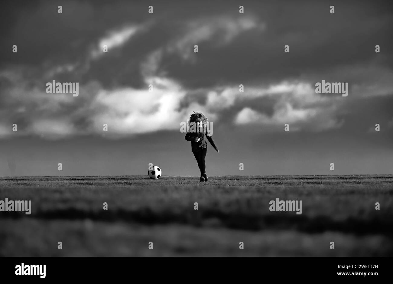 Young boy kicks the soccer ball. Football player in motion, boy in ...
