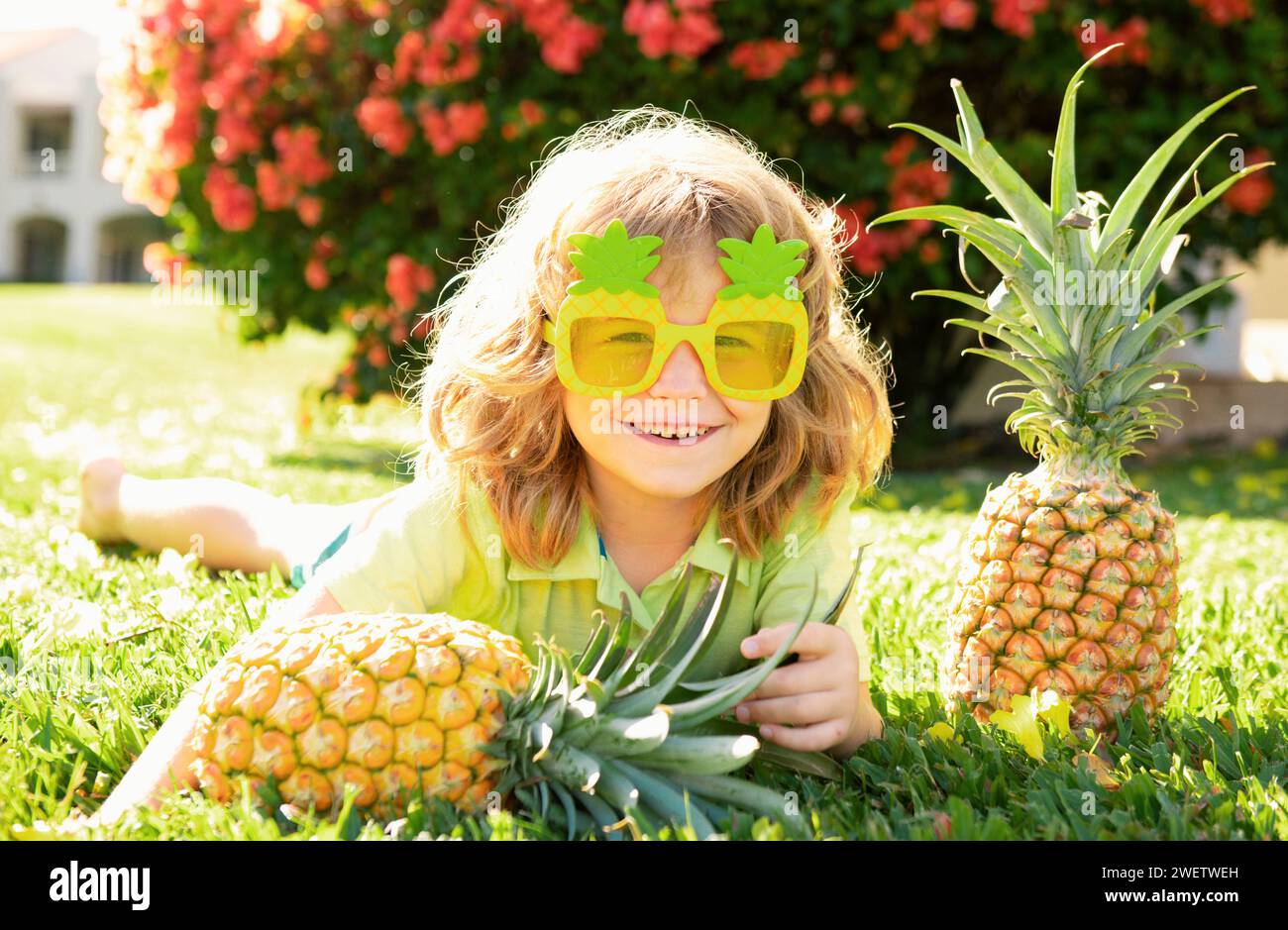 Child wearing funny sunglasses with pineapple. Kid with tropical fruit ...