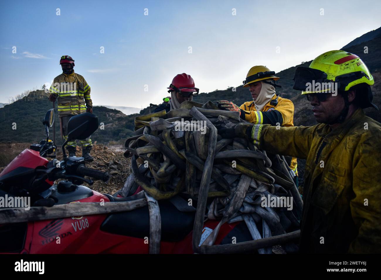 Bogota, Colombia. 25th Jan, 2024. Firefighters work to extinguish the ...