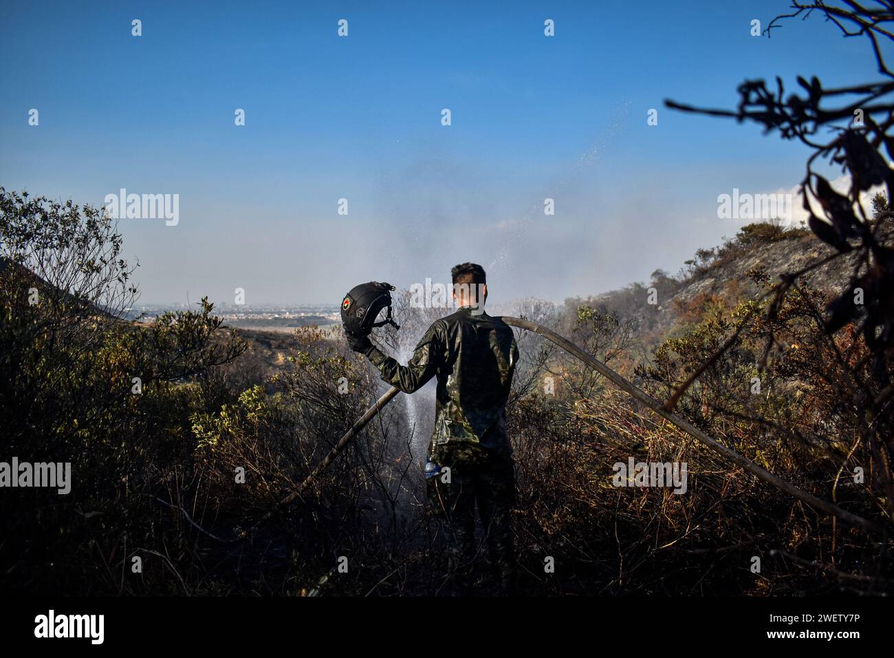 Bogota, Colombia. 25th Jan, 2024. Firefighters work to extinguish the ...