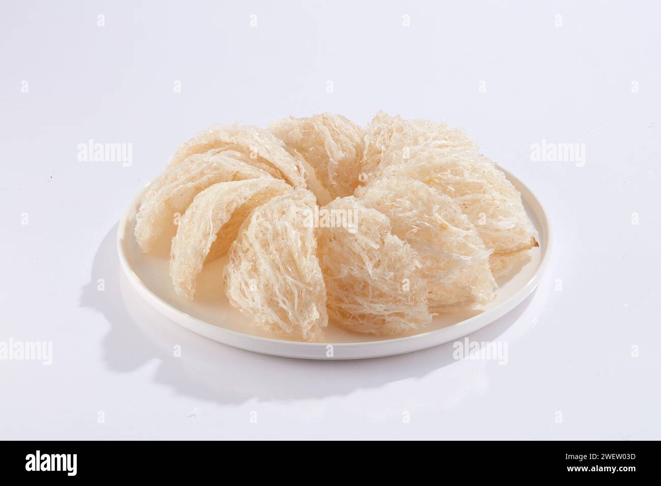 Close-up of raw bird's nests neatly arranged on white circular plate on ...