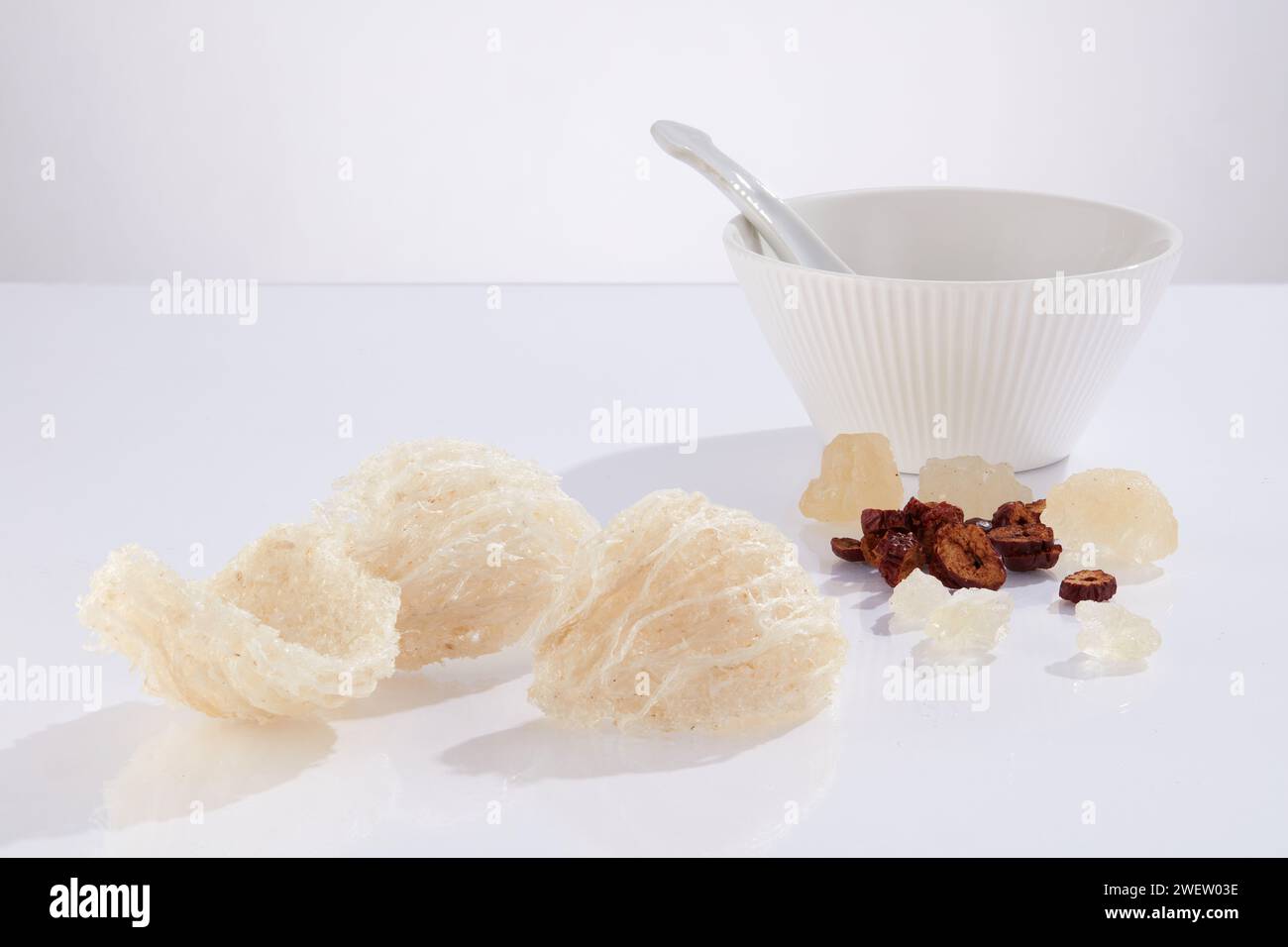 Scene of some edible bird’s nest, rock sugar, jujube and white bowl on ...