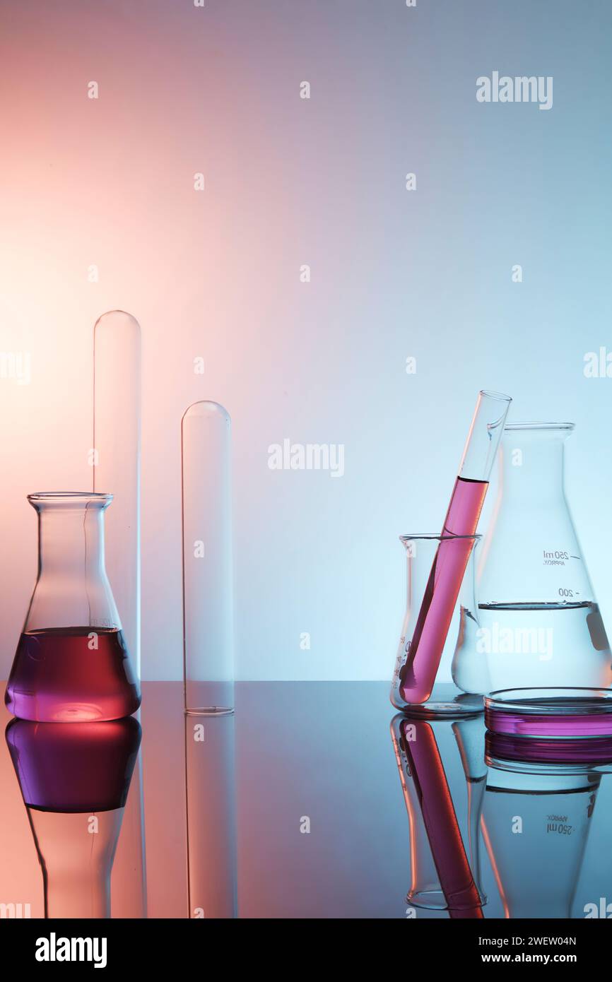 Science and medical background with lab glassware filled purple liquid ...