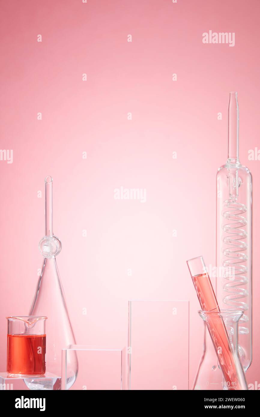 Lab theme with lab glassware filled pink liquid on pink background ...
