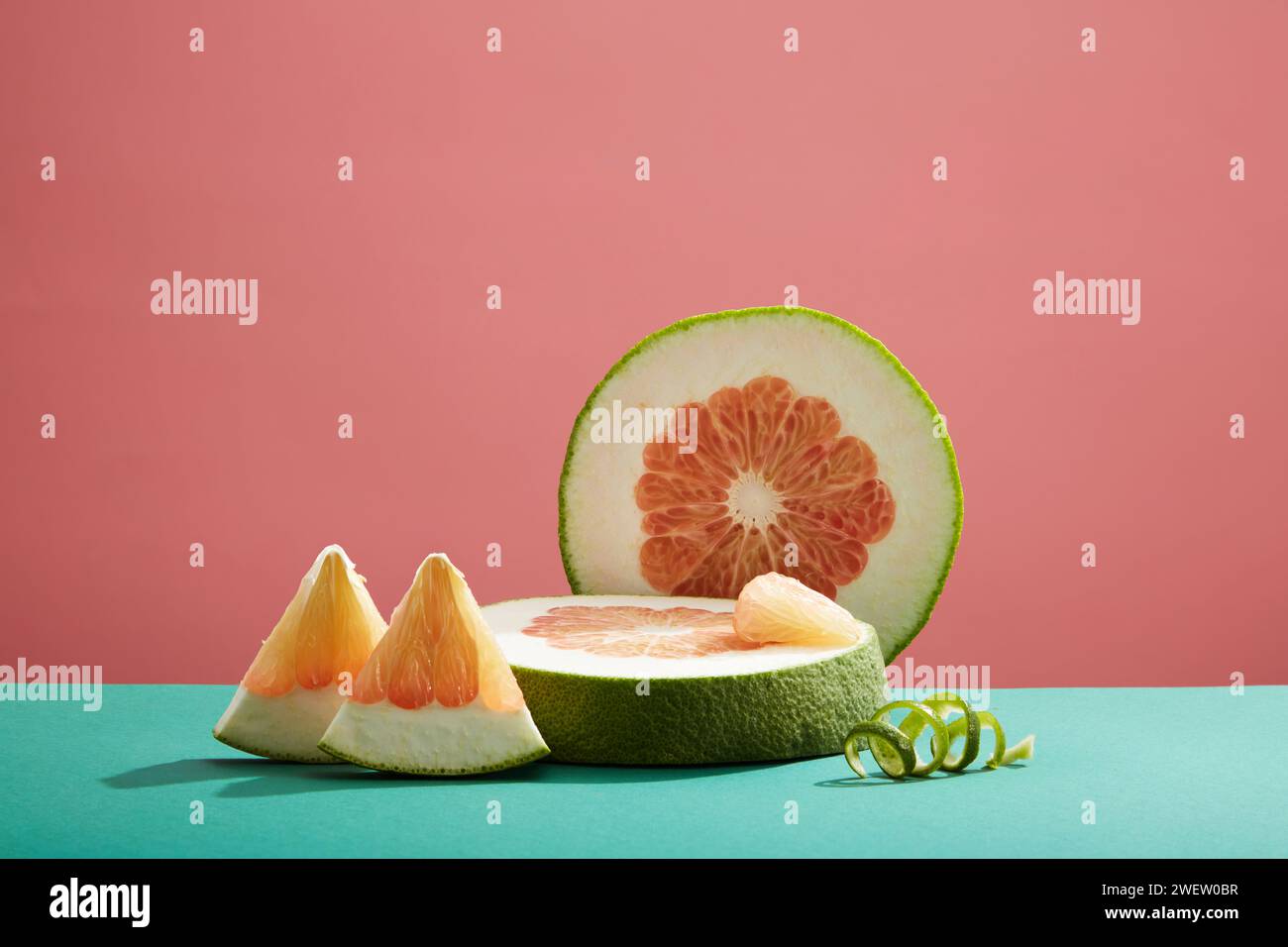 Front view of pieces fresh grapefruit on pink background. Sliced pink ...