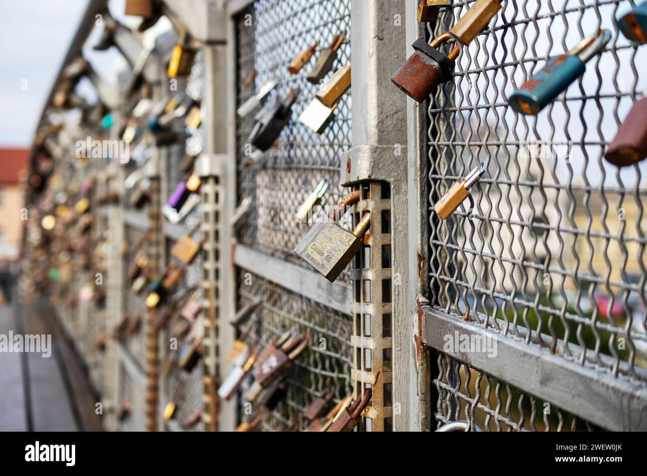 a row of different sized padlocks on the bridge railing Stock Photo - Alamy