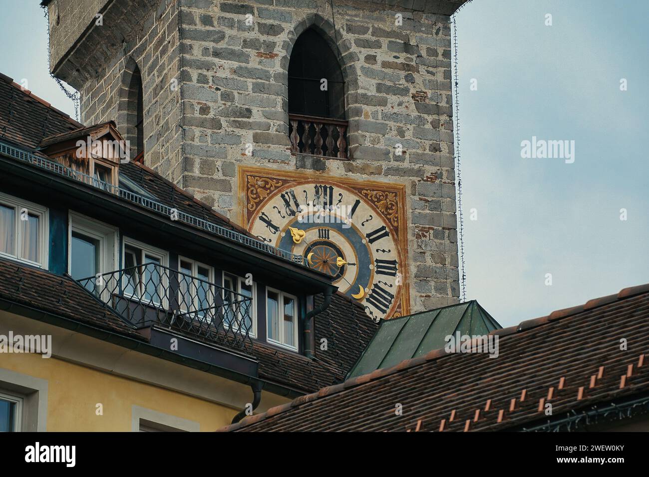 A towering clock structure adjacent to a slope-side building Stock ...