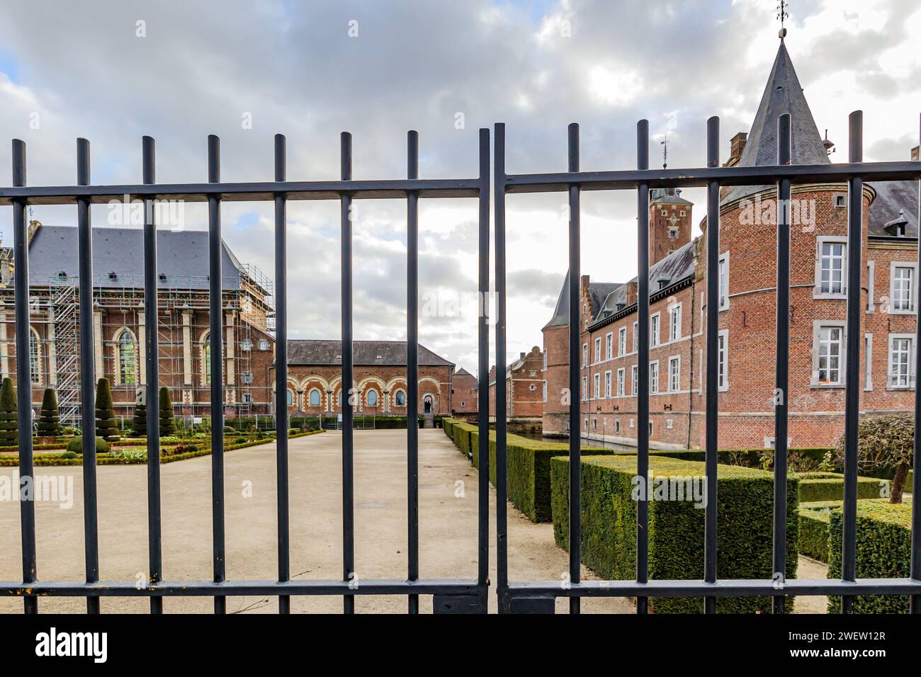 Closeup of wrought steel fence with outside garden and part of former ...