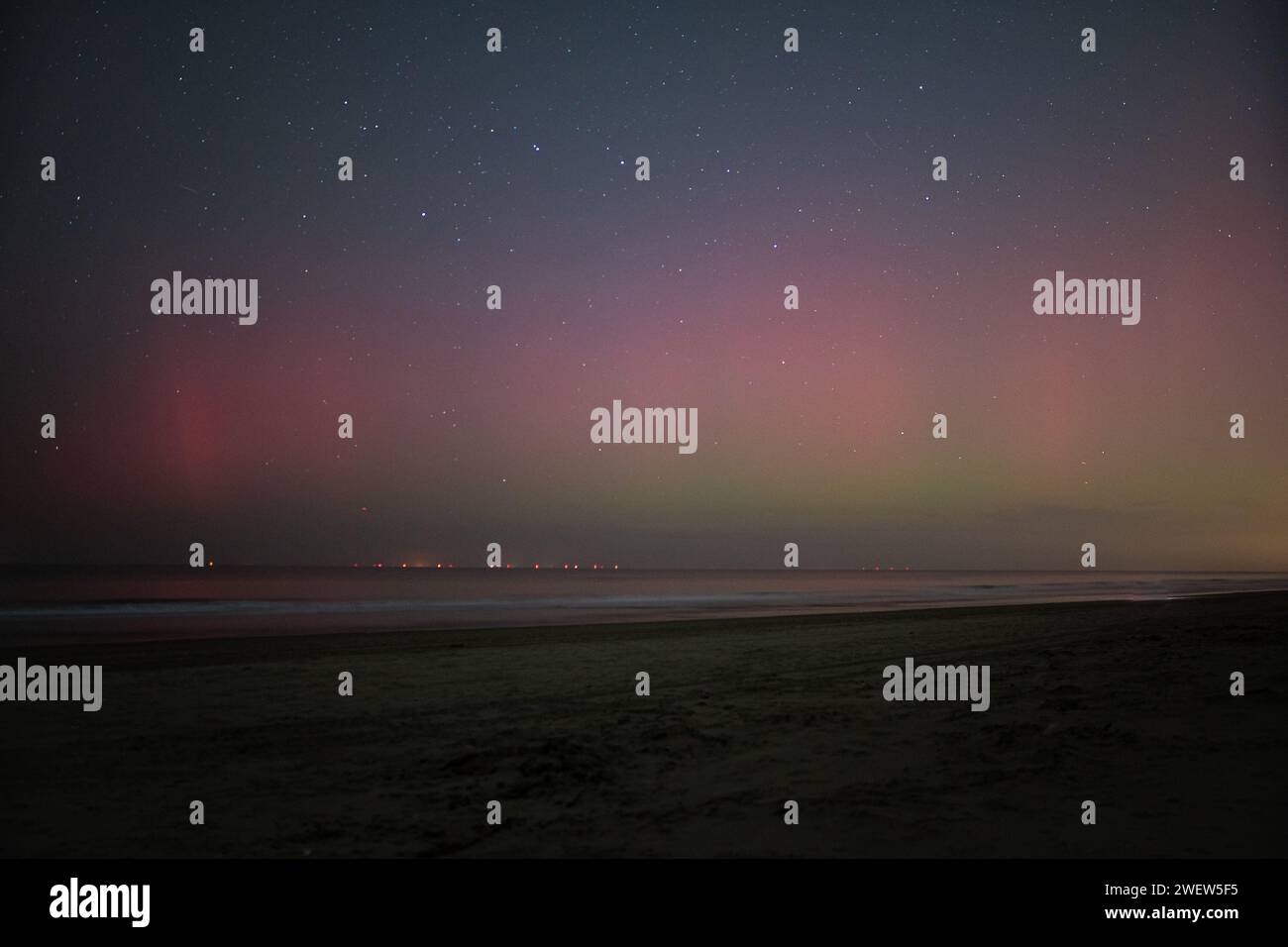 Purple and green glow of the northern lights (Aurora borealis) over the ...