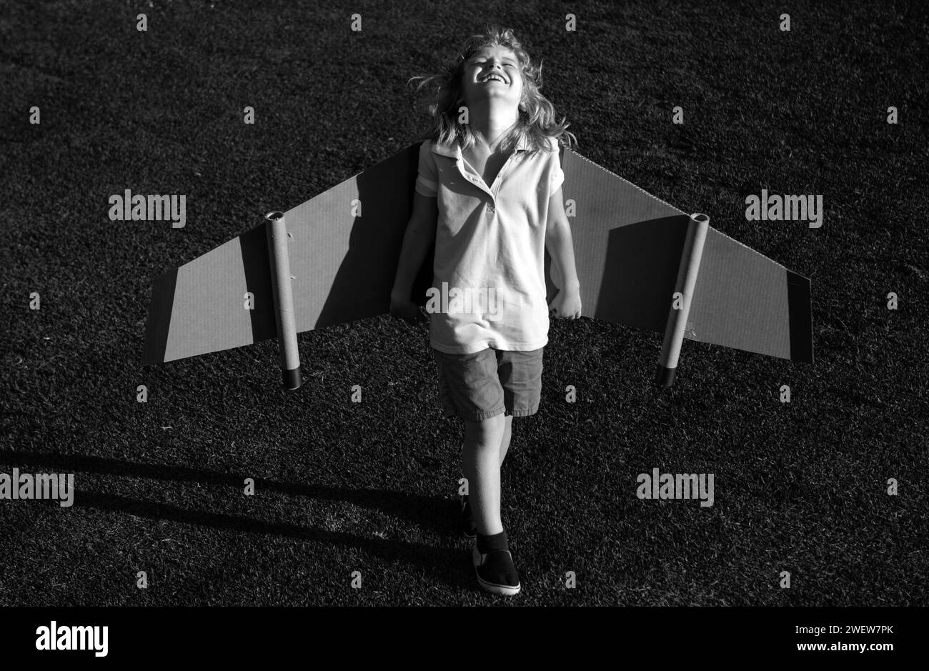 Laughing child boy dreams and travels. Boy with airplane toy outdoors ...