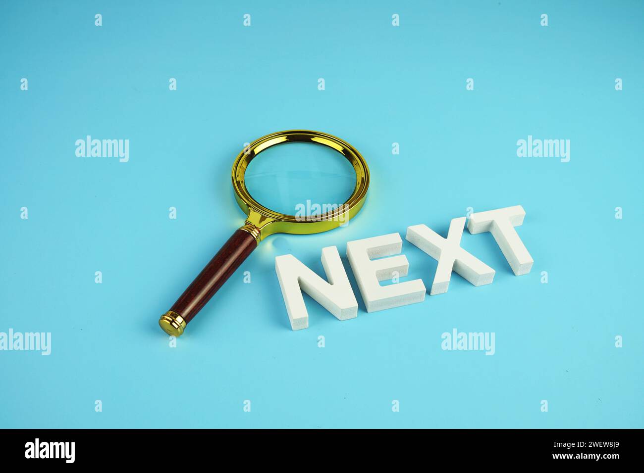 NEXT alphabet letters with magnifying glass on blue background Stock ...