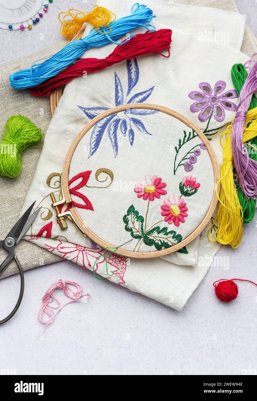 The process of hand embroidering a napkin with colored threads on white ...