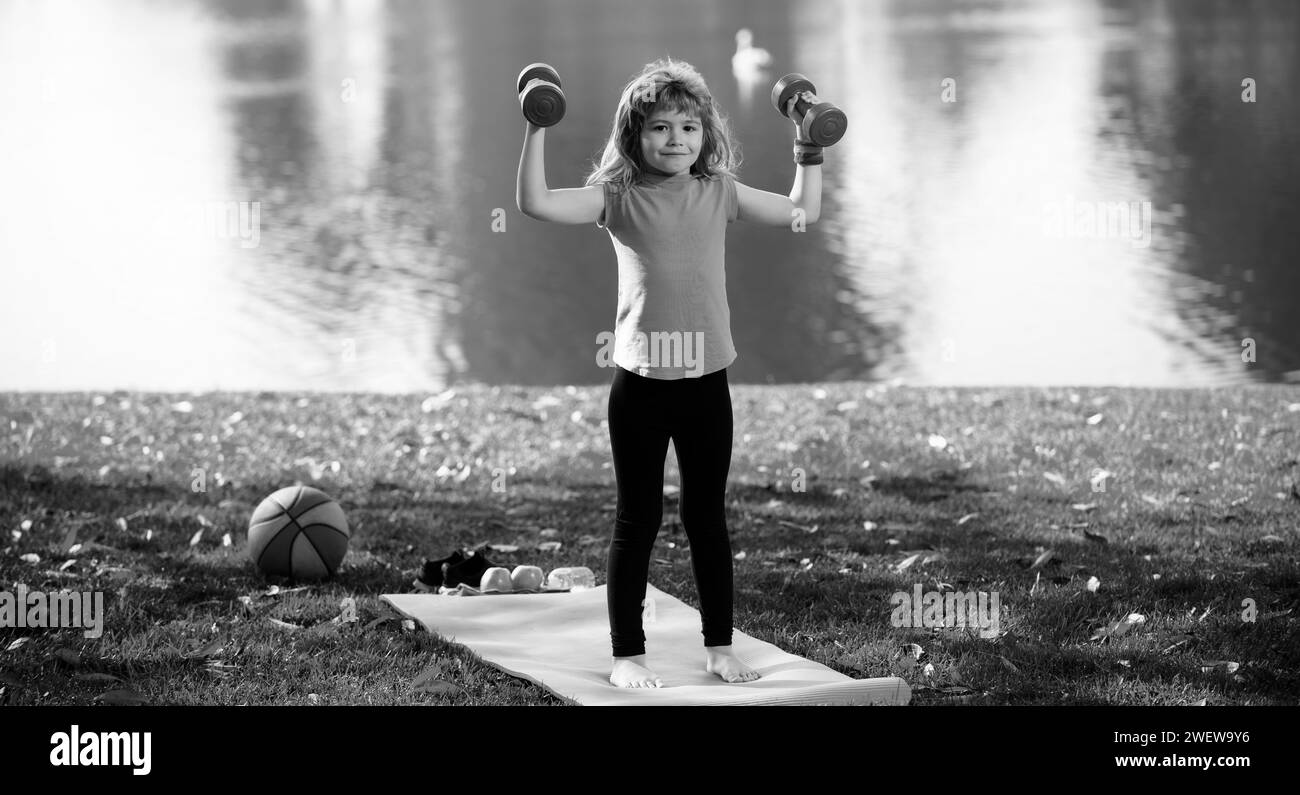 Kids sport. Healthy kid boy with dumbbell exercise outdoor. Little ...