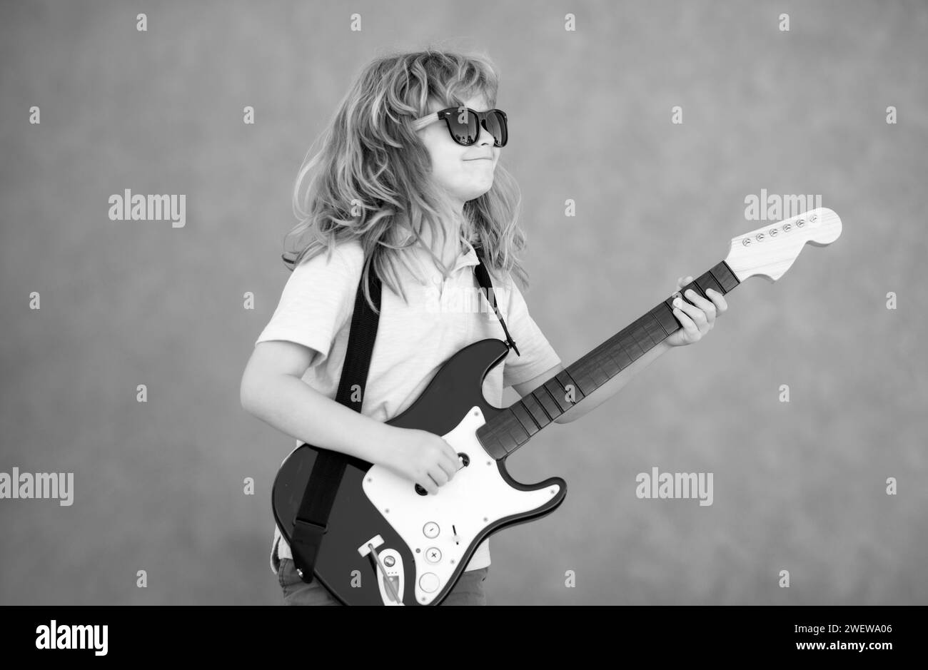 Little boy playing guitar outdoor. Child musician playing the guitar ...